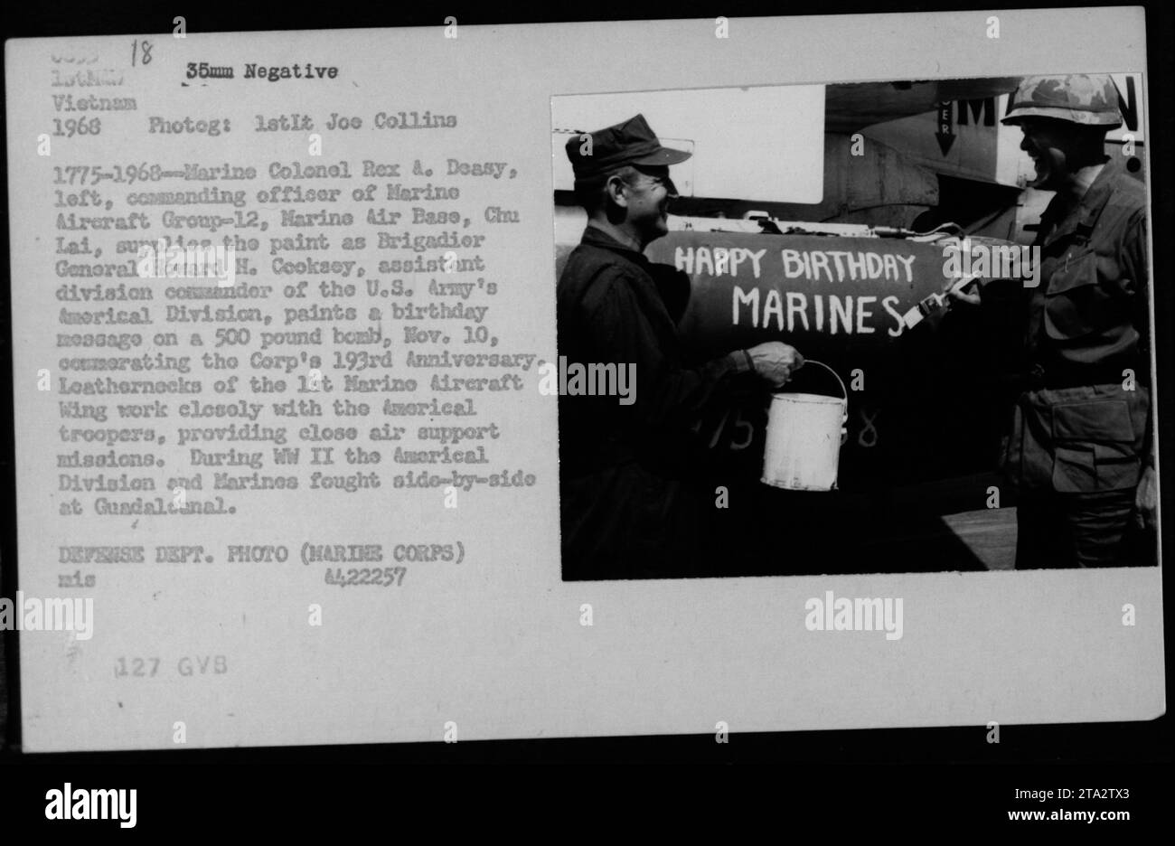 Marine Colonel Rex Deasy provides paint while Brigadier General Howard ...