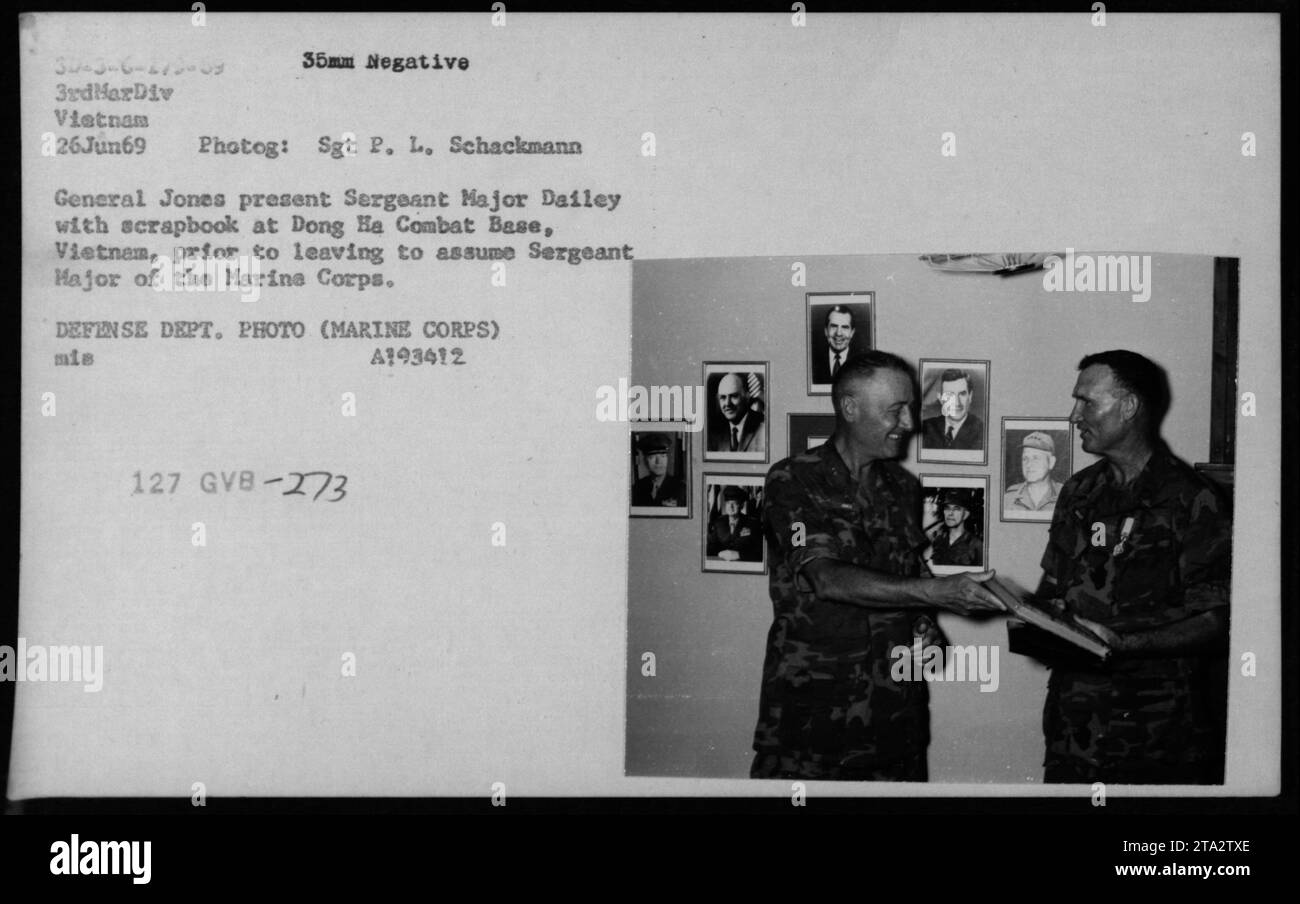 Sergeant Major Dailey receiving a scrapbook from General Jones at Dong ...