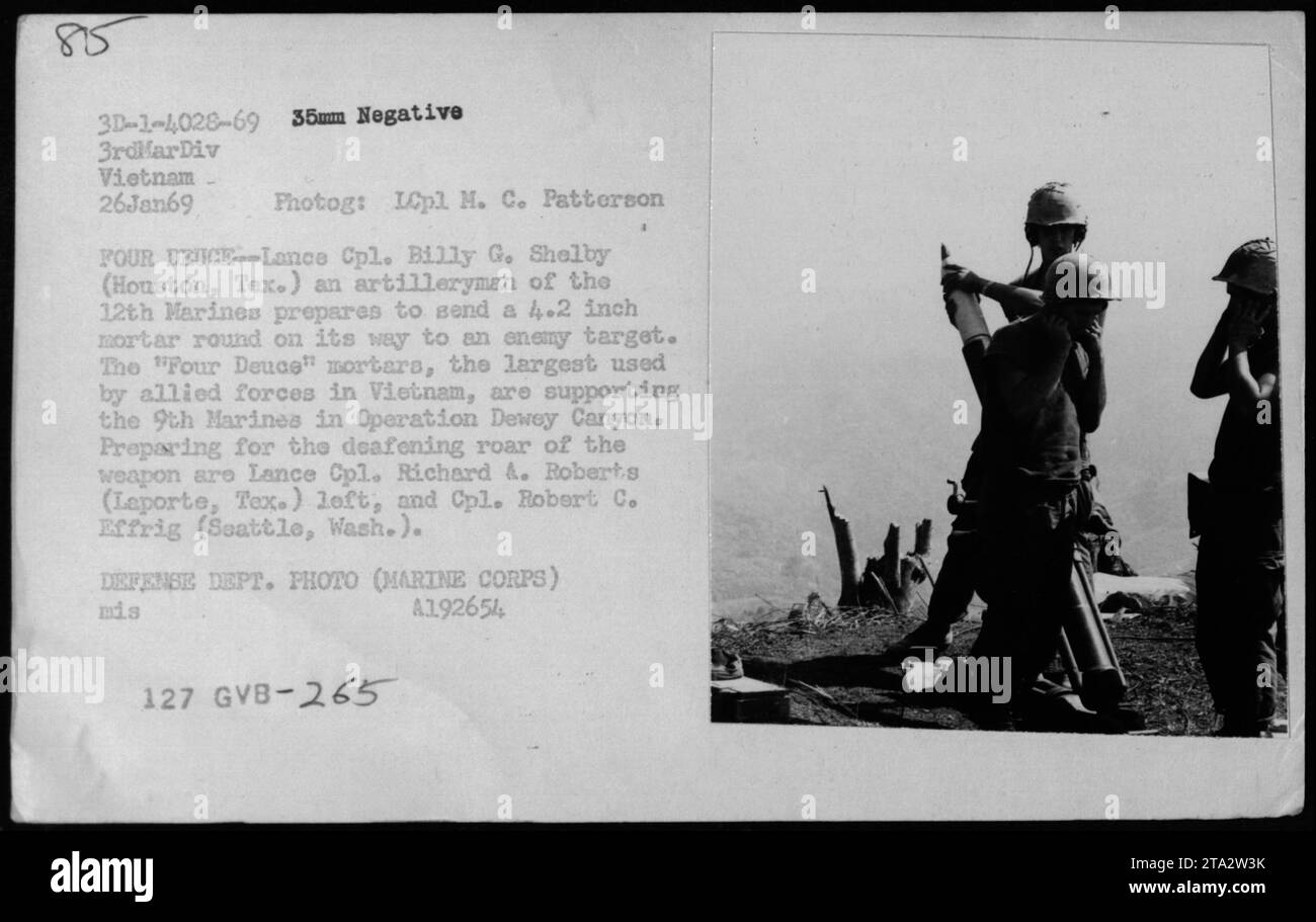 Lance Cpl. Billy G. Shelby prepares a 4.2-inch mortar for launch during ...