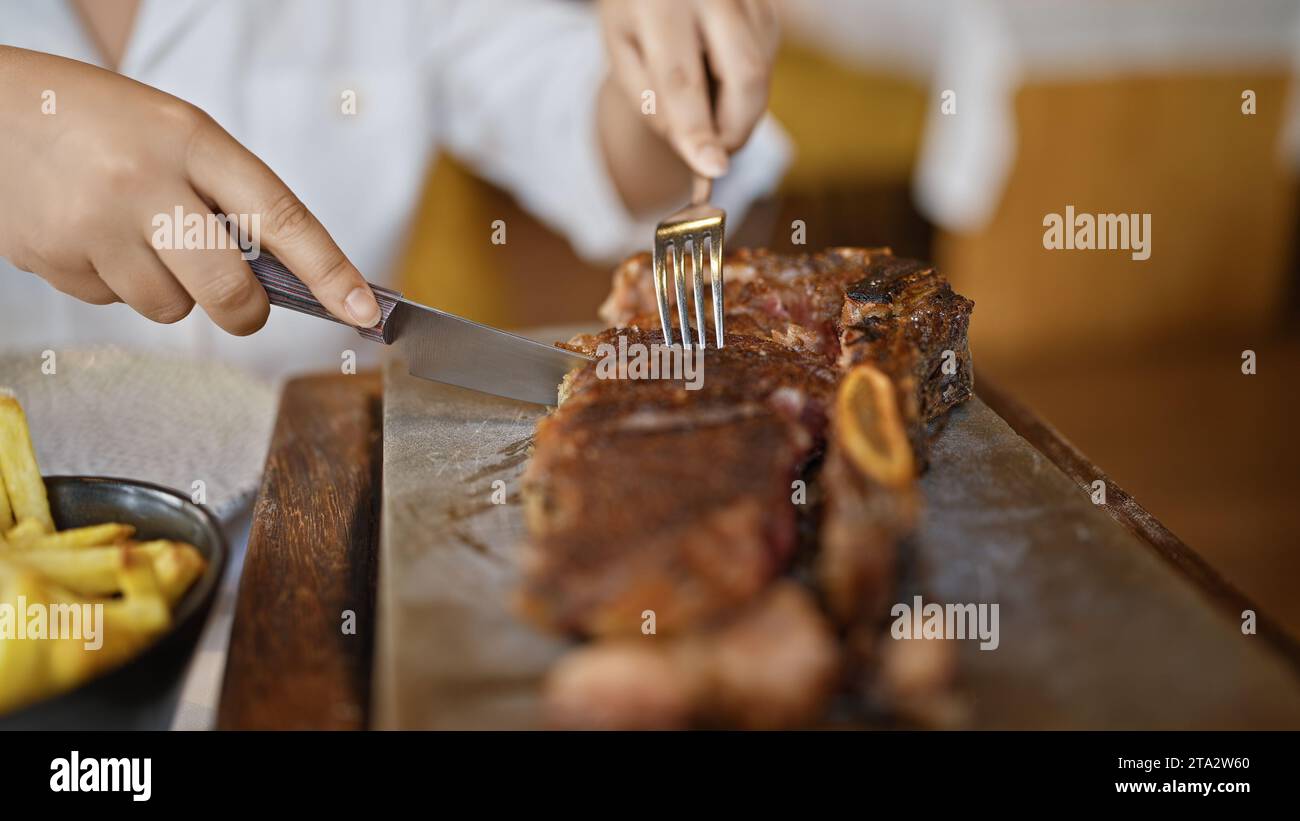 Young woman carving meat at the restaurant Stock Photo - Alamy