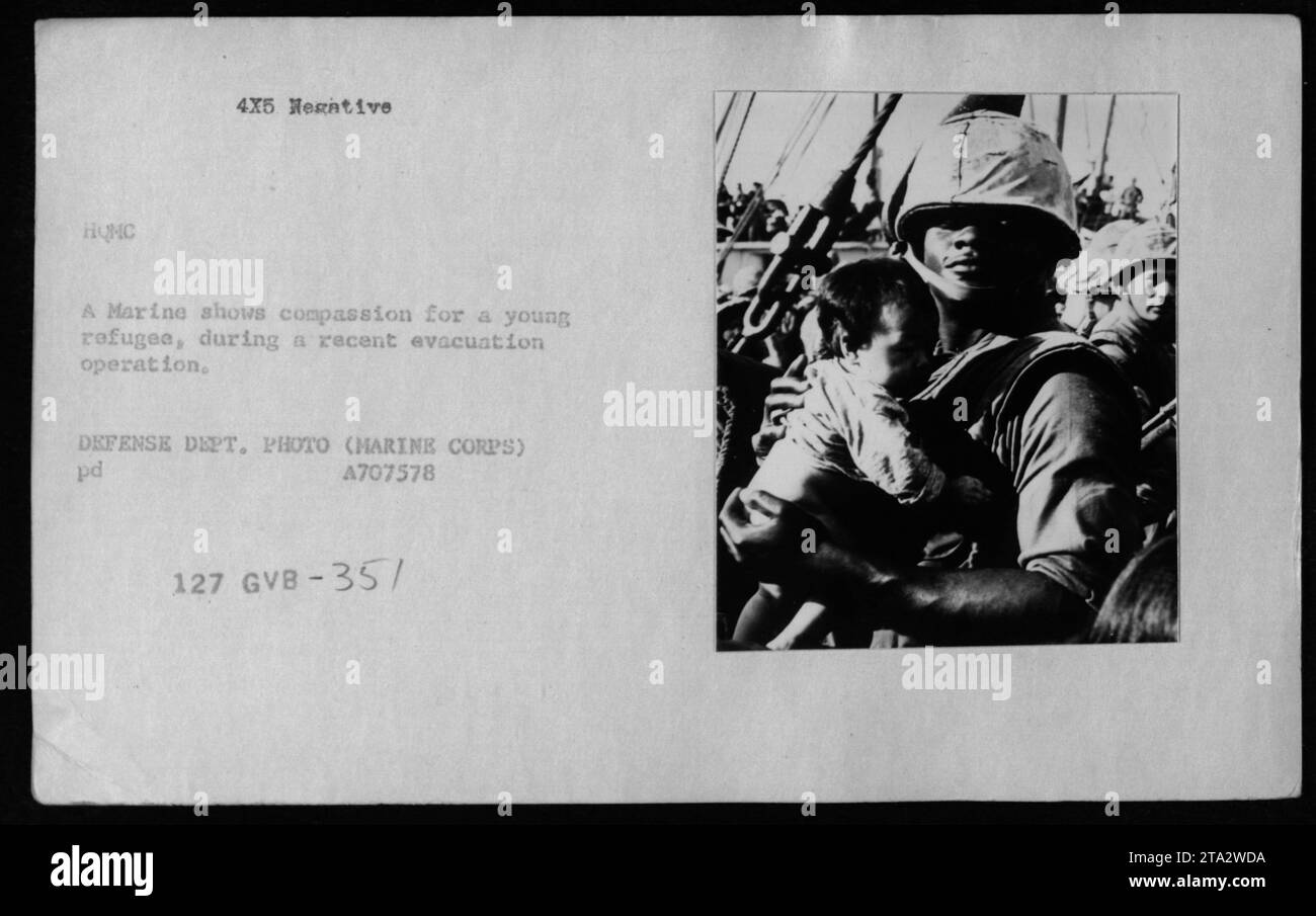 A Marine shows compassion for a young Vietnamese refugee during an ...