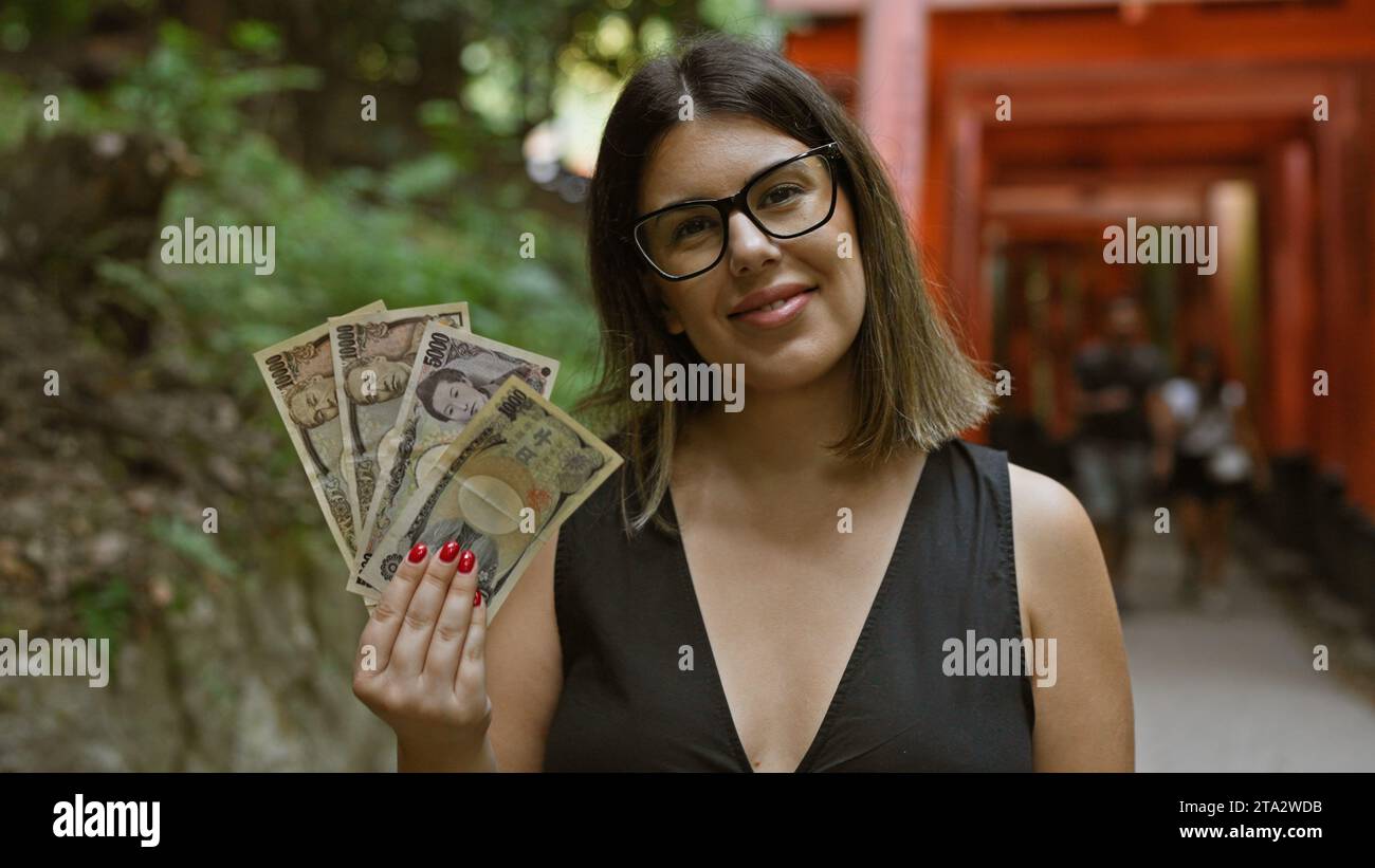 Gorgeous hispanic woman in glasses taking the financial high road ...