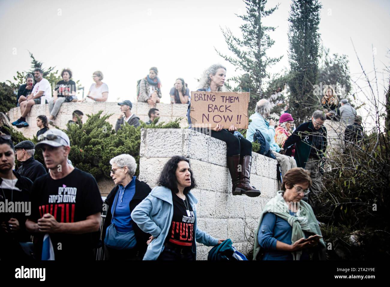 A woman holds a 'Bring Them Back Now' sign during a rally calling for ...