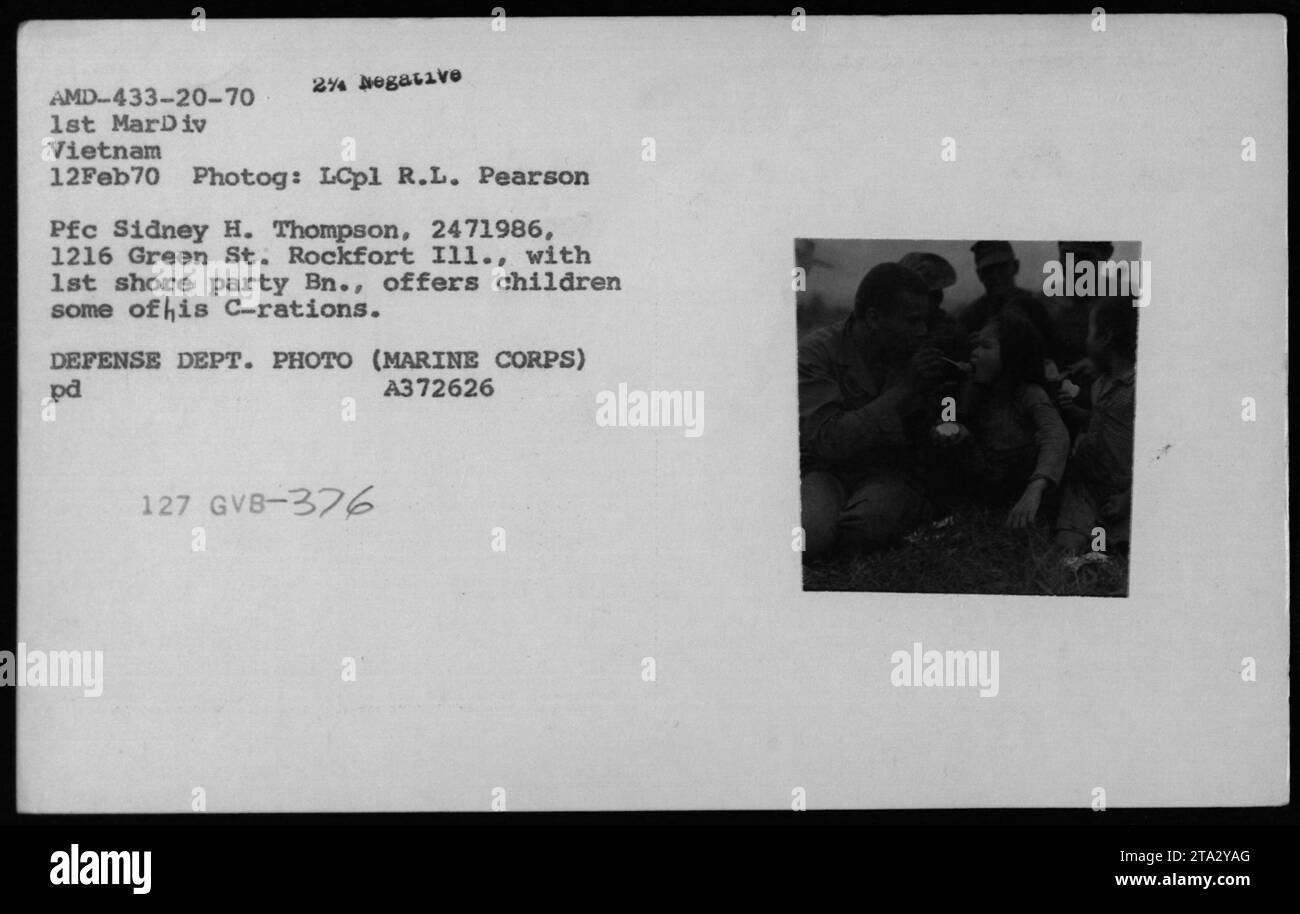 Pfc Sidney H. Thompson, a member of the 1st shore party Bn., is seen ...