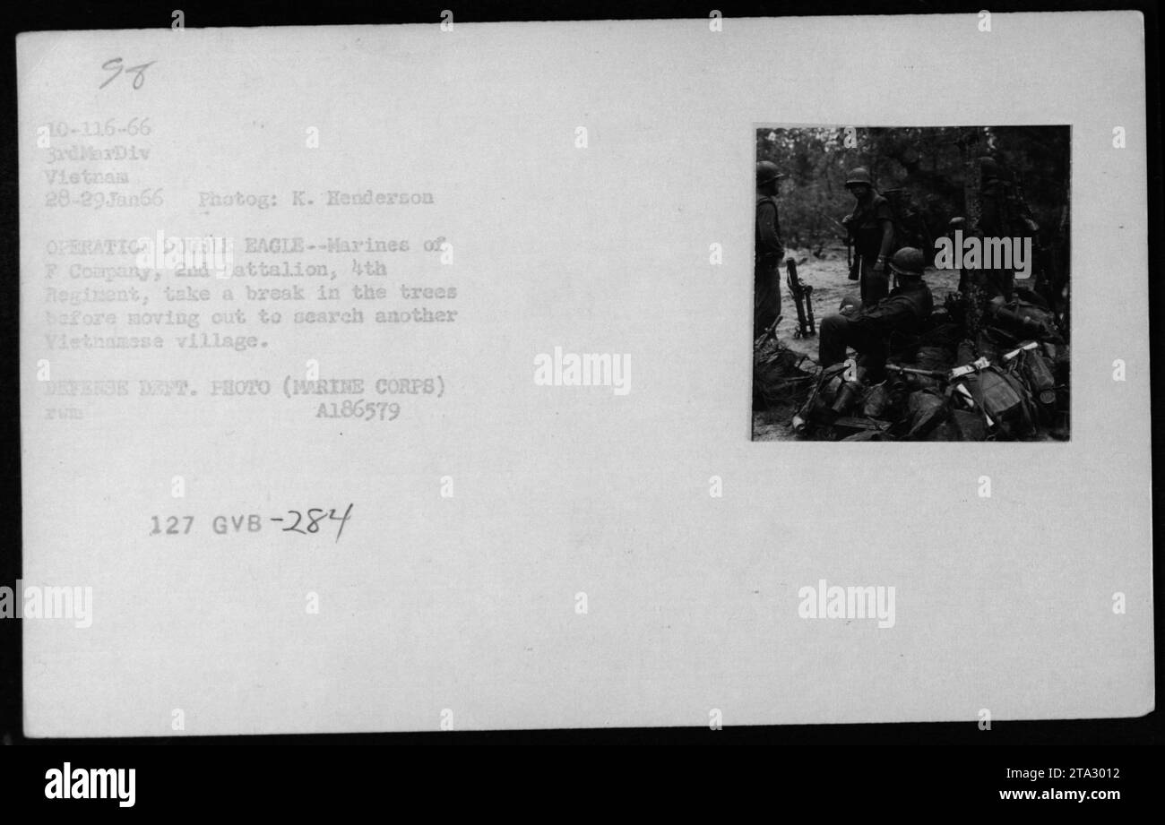 Marines of F Company, 2nd Battalion, 4th Regiment, pause in a wooded area on January 28, 1966 ...