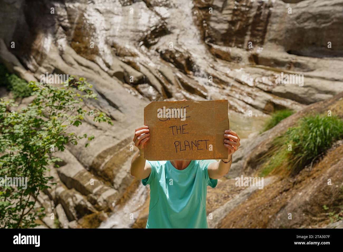 Activist woman holding a paper with ecological message to save the ...