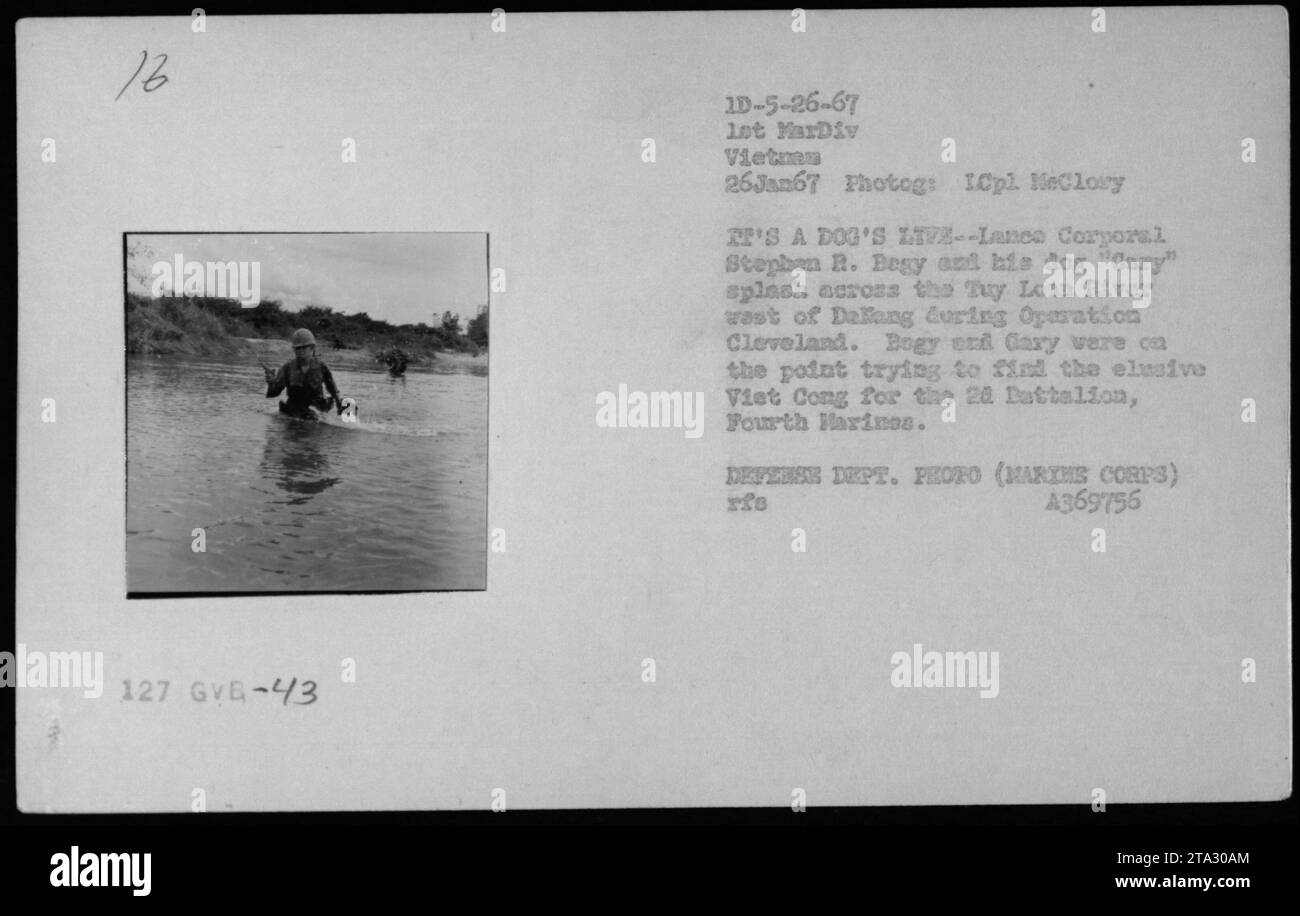 Lance Corporal Stephen R. Begy with his dog Bogy crosses the Tuy Loan ...
