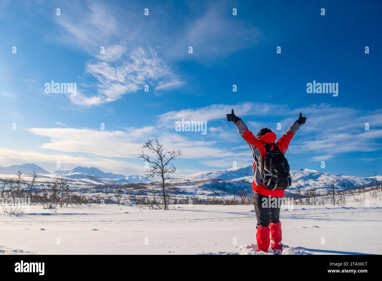 Sporty person in red sport jacket enjoys snow and breathtaking ...