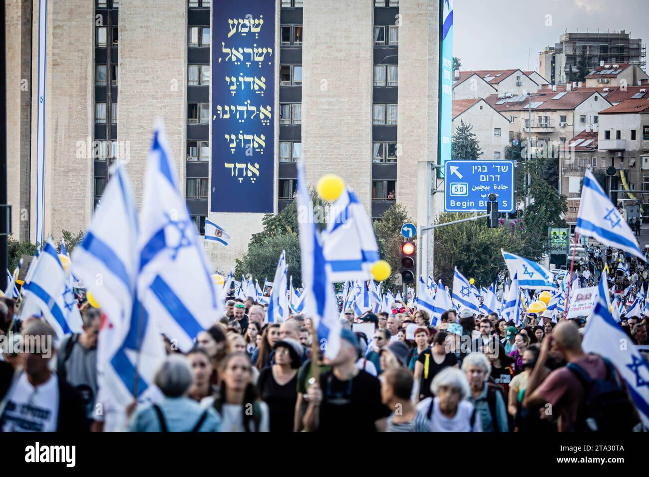 People march through the streets while holding Israel flags calling for ...
