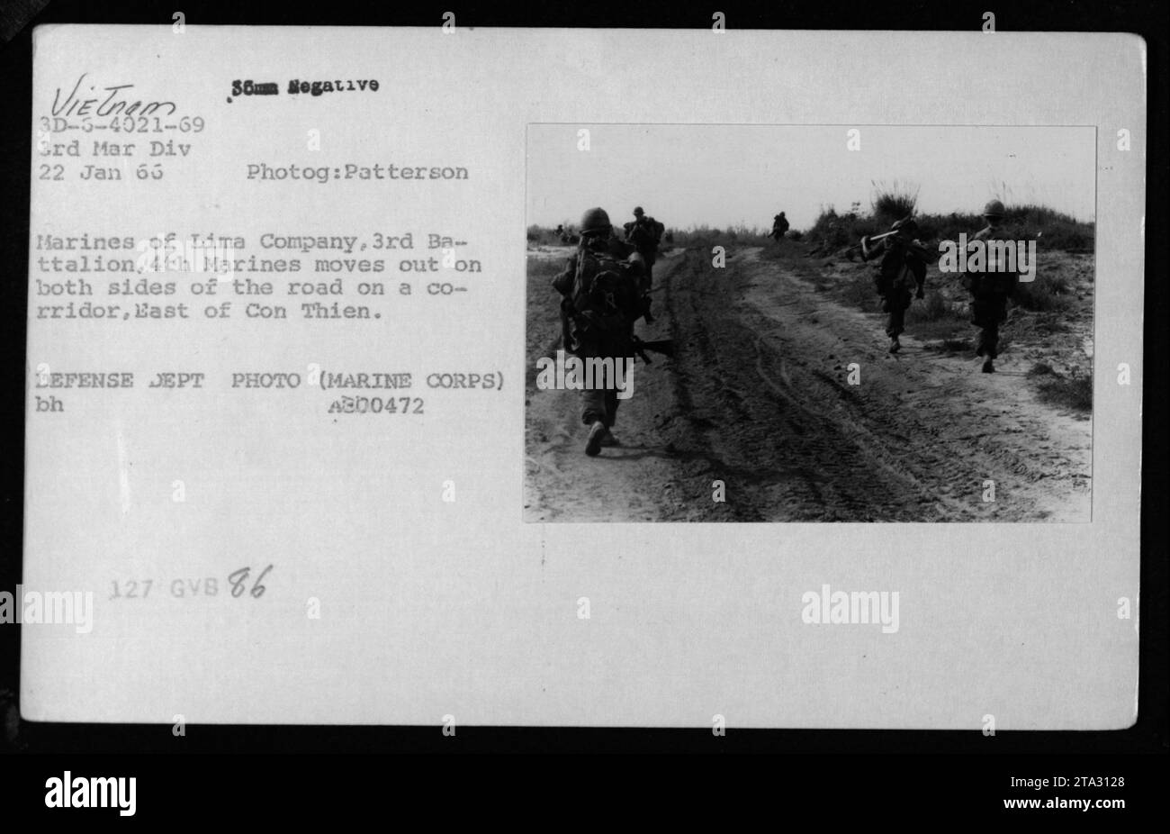 Marines from Lima Company, 3rd Battalion, 4th Marines, move along a ...
