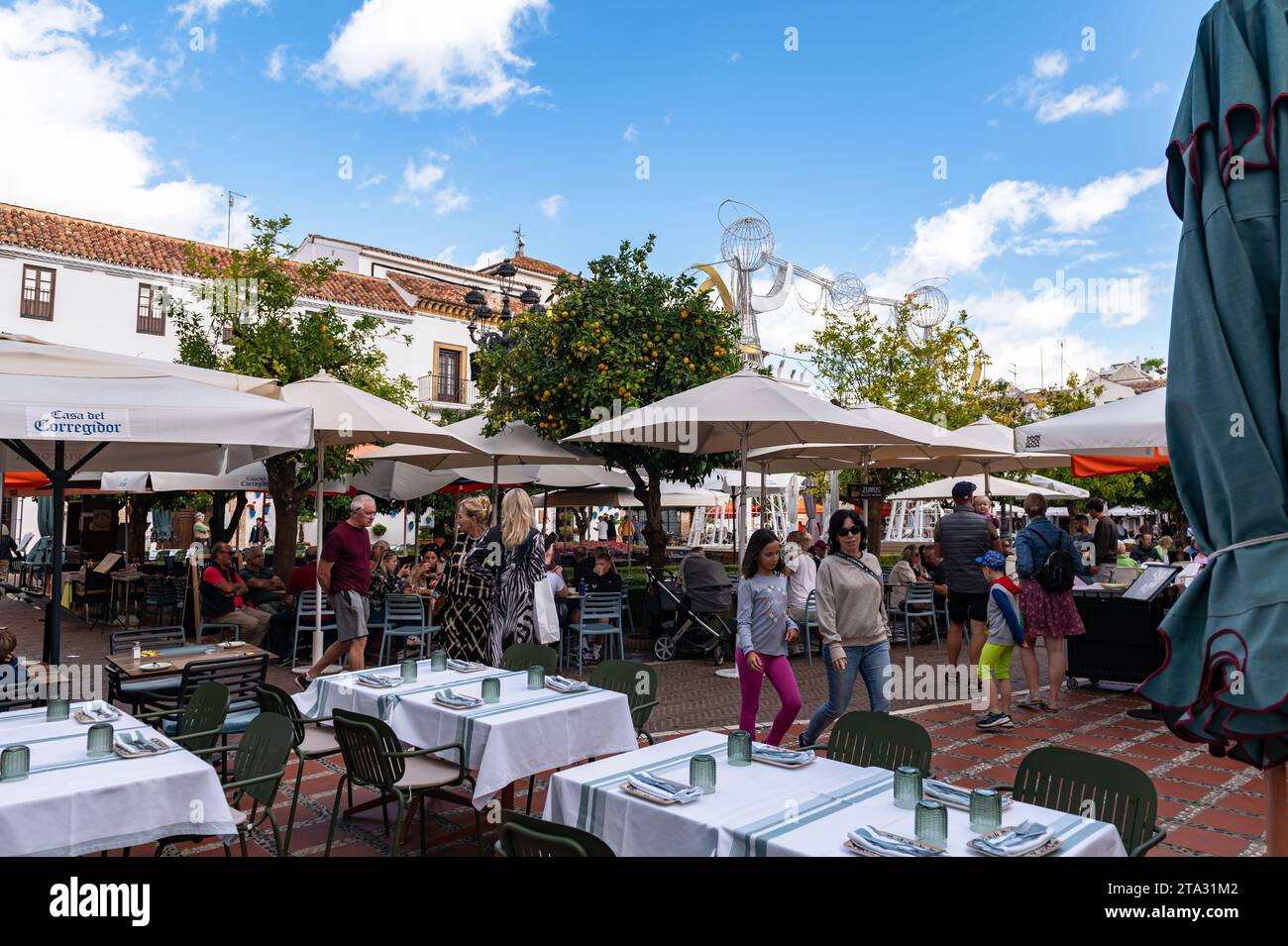 Cafe tables on Streets of Marbella, Spain Stock Photo - Alamy