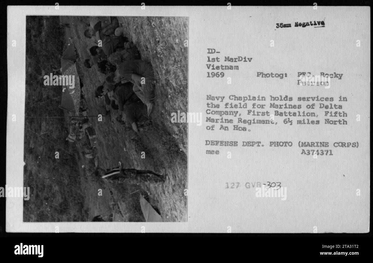The photograph shows a Navy Chaplain conducting field religious ...