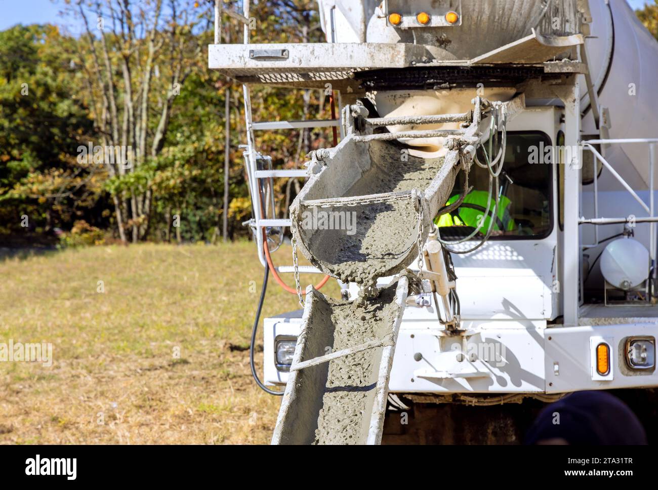 Concrete mixer truck poured liquid cement concrete at construction site ...