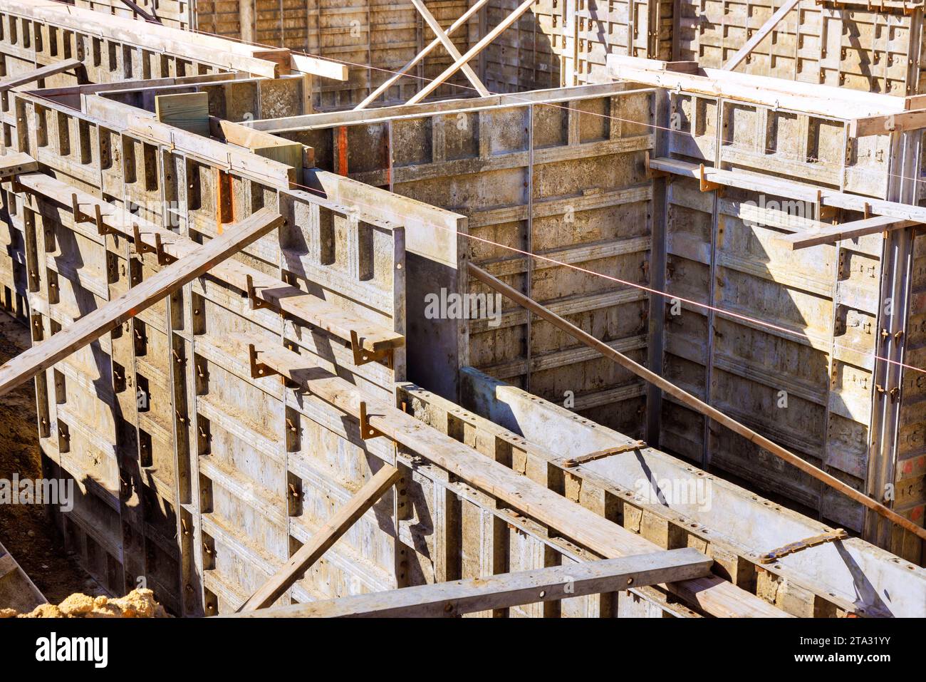 Metal formwork is ready for pouring concrete for building foundation ...