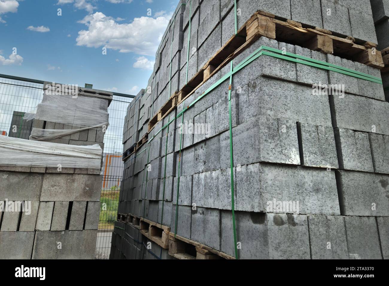 Big gray concrete bricks on pallets on a construction outdoor store ...