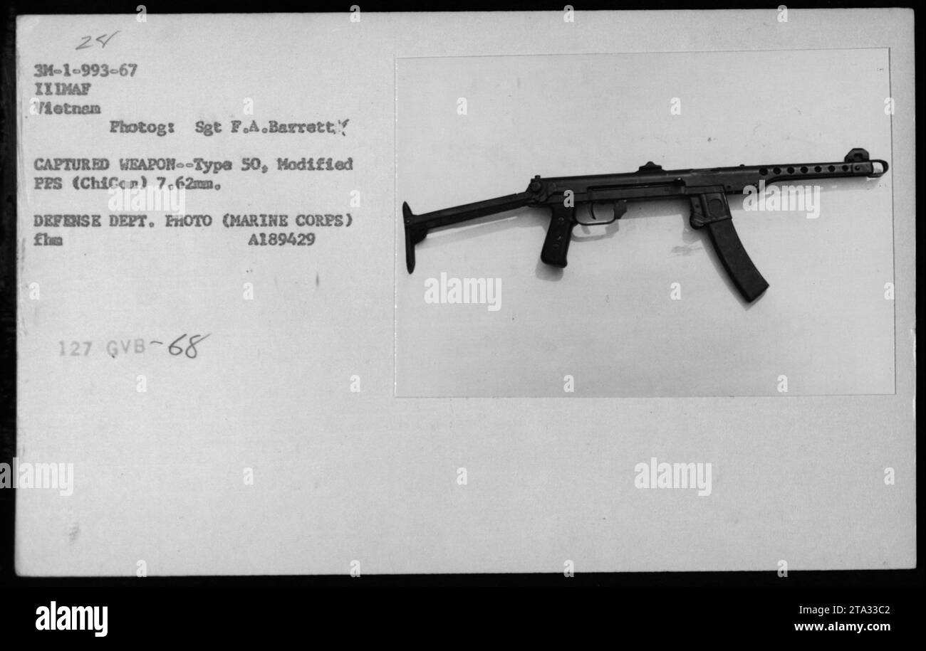 Marines examine a captured Type 50 Modified PPS 7.62mm weapon during ...