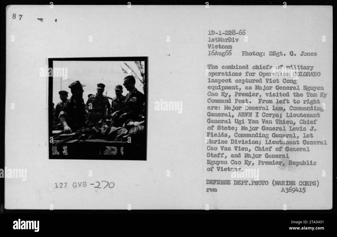 Combined military leaders inspect captured Viet Cong equipment at Tam ...