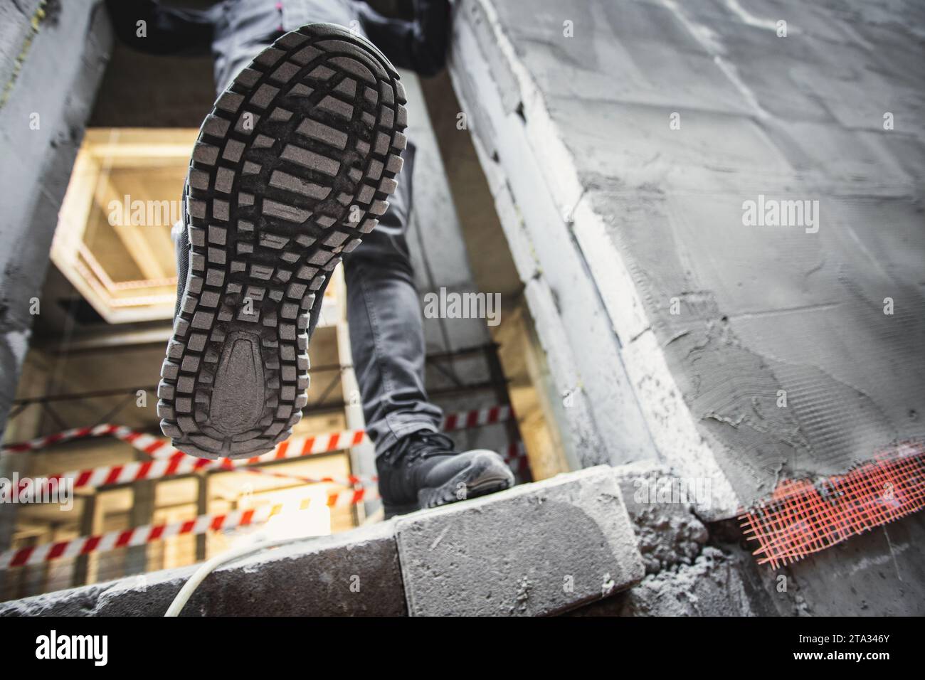 Tread construction safety shoes on a worker walking on a construction ...
