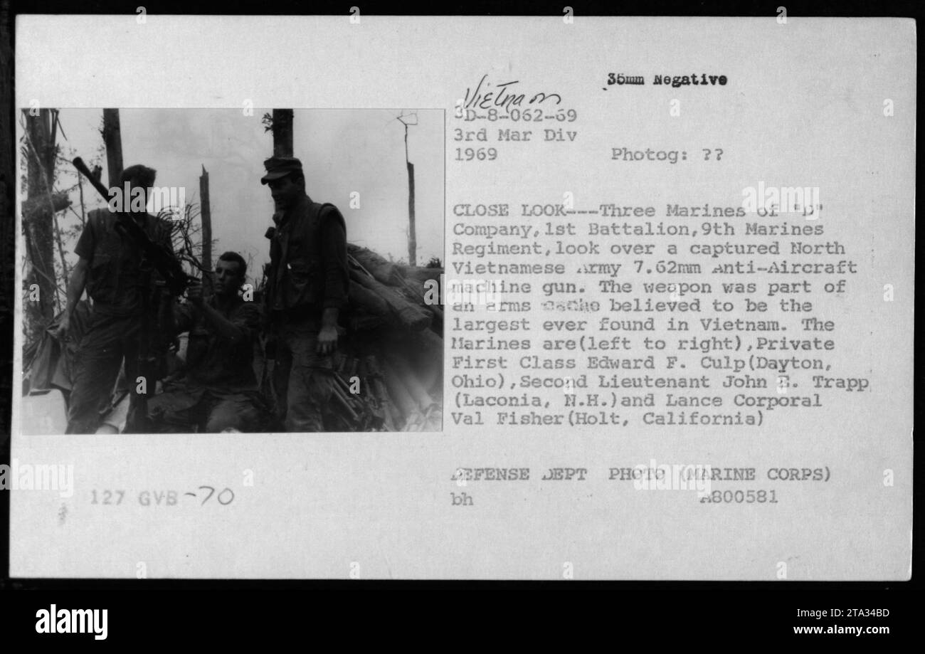 Three Marines from the 3rd Marine Division examine a captured 7.62mm ...