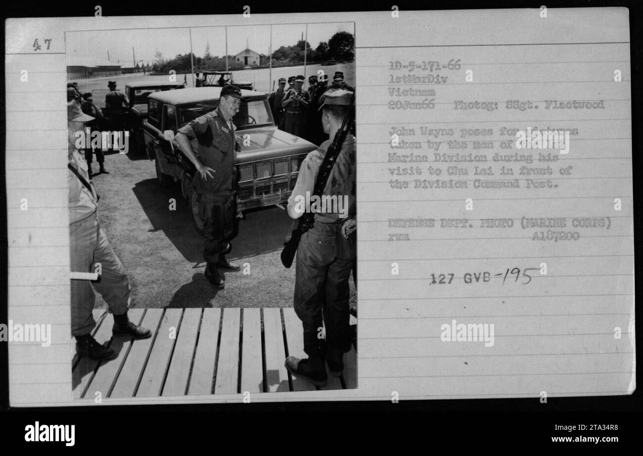 Actor John Wayne poses for pictures in front of the Division Command ...