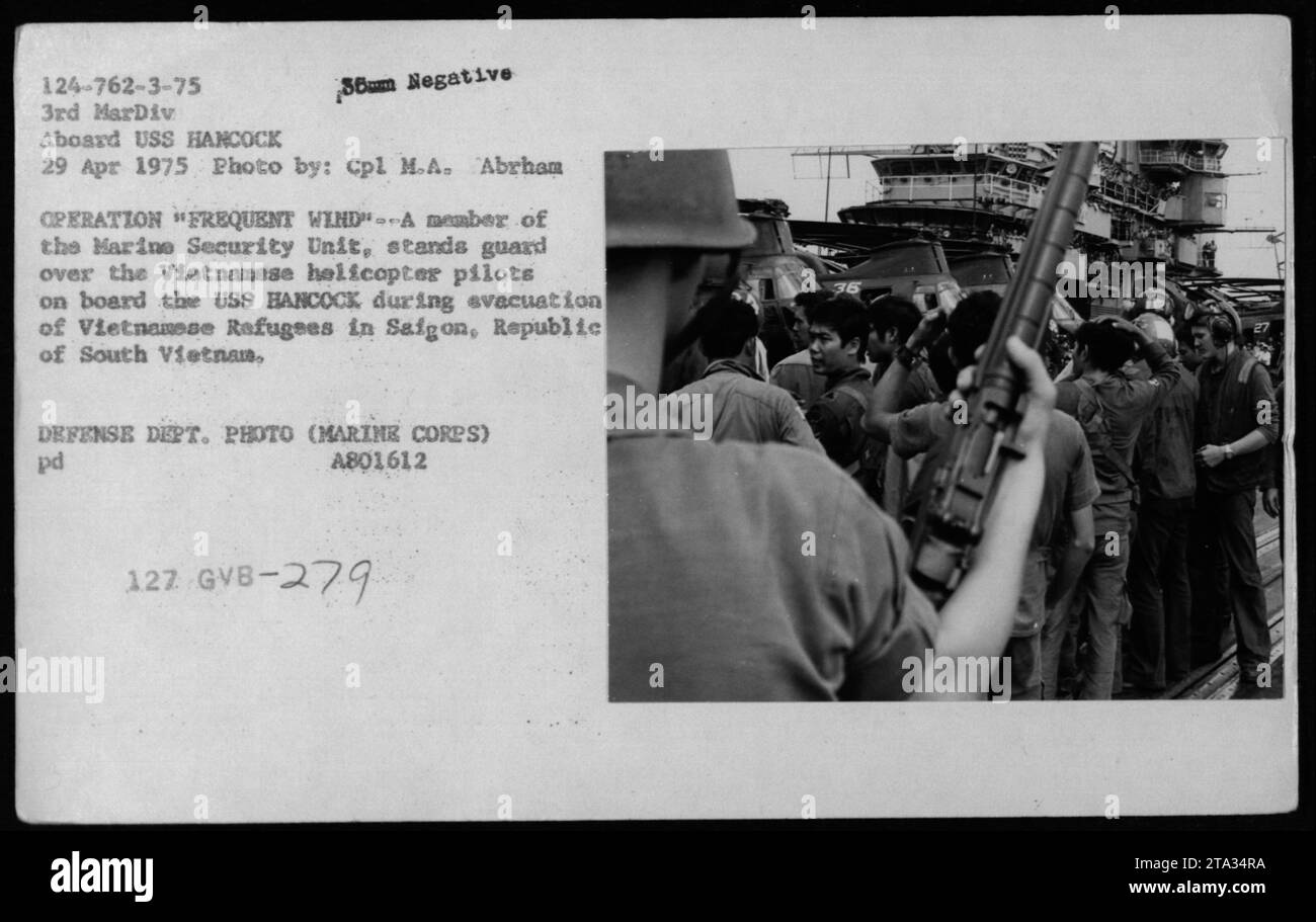 A member of the Marine Security Unit stands guard over Vietnamese ...