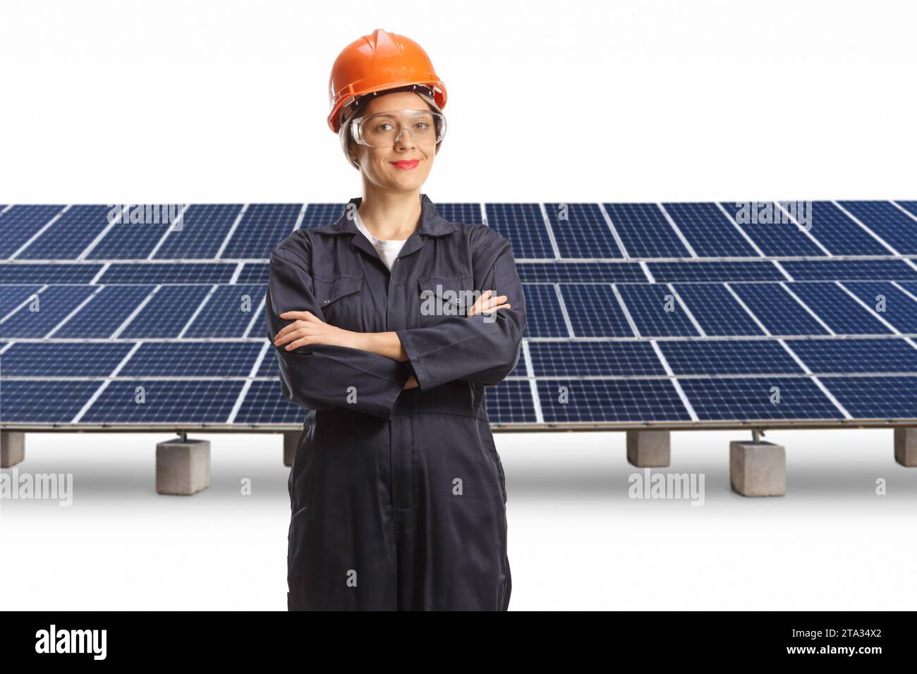 Female worker in a uniform posing in front of a solar farm isolated on ...