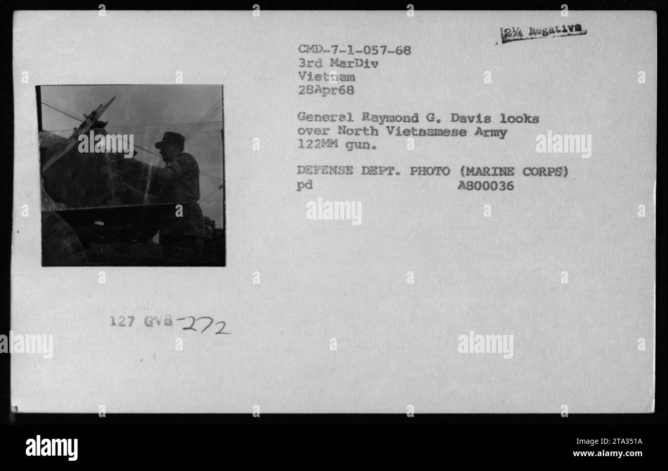 General Raymond G. Davis examines a captured North Vietnamese Army ...