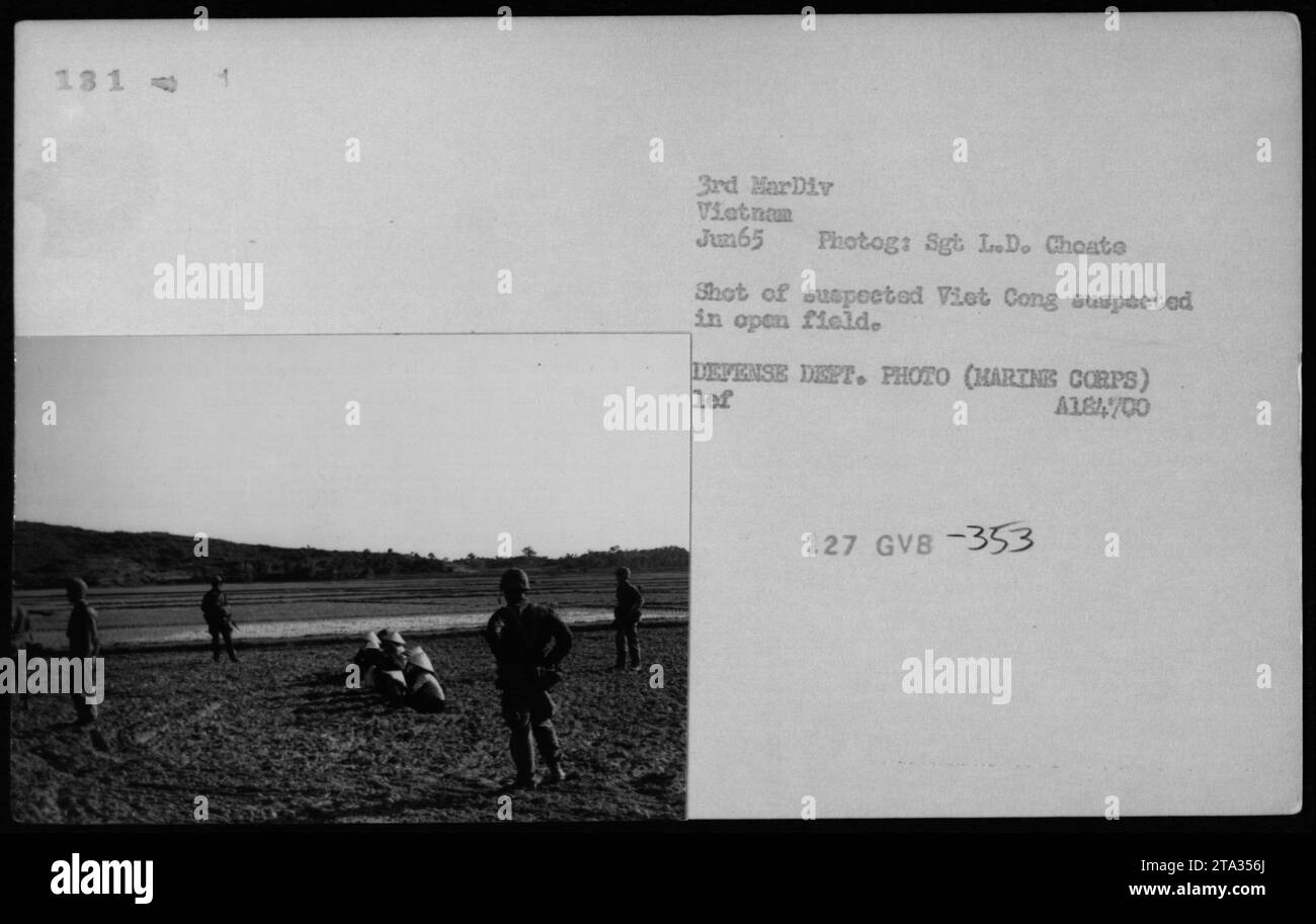 Vietnamese soldiers observe suspected Viet Cong prisoners in an open ...