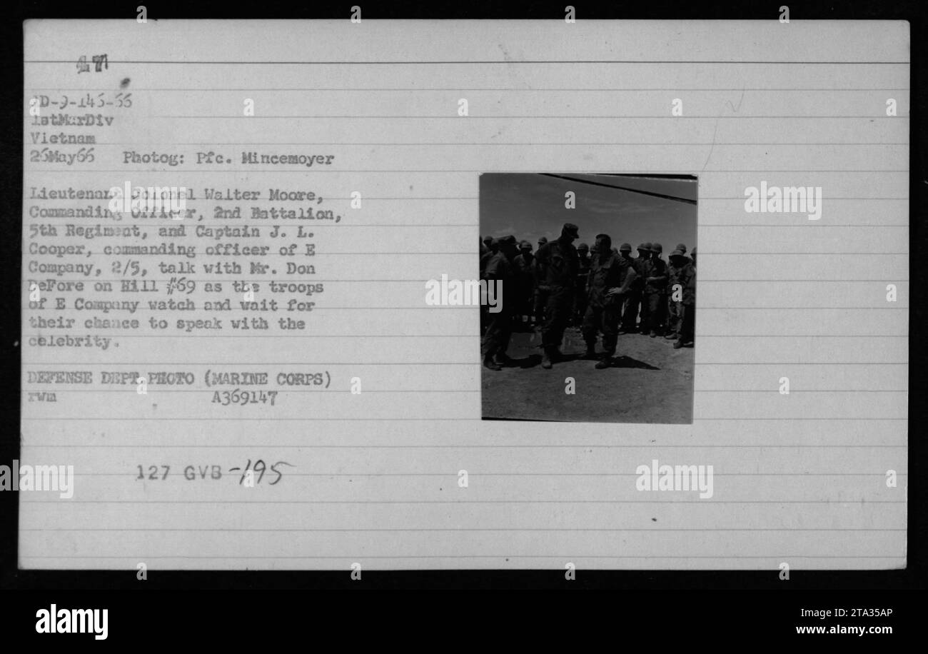 Lieutenant Colonel Walter Moore and Captain J. L. Cooper speak with ...