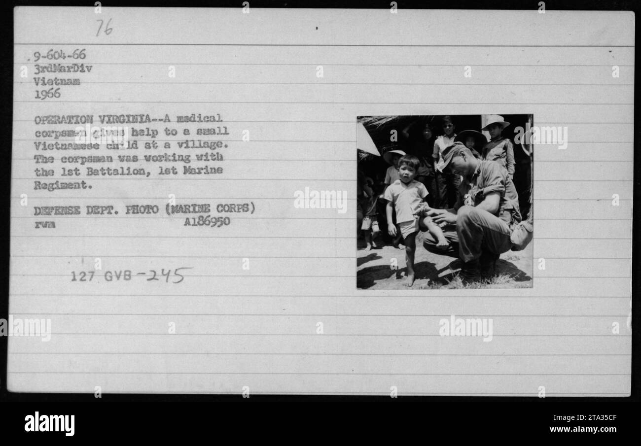 A medical corpsman provides aid to a young Vietnamese child in a ...