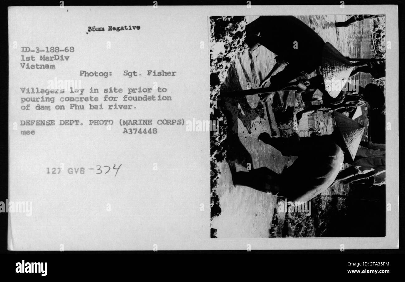 Vietnamese villagers take a break before building a dam on Phu Bai ...