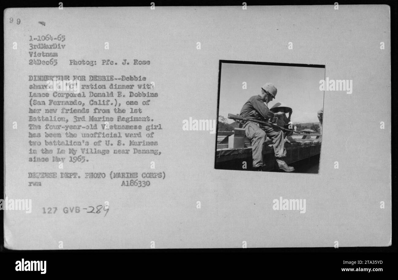 A four-year-old Vietnamese girl named Debbie shares a "c" ration dinner ...