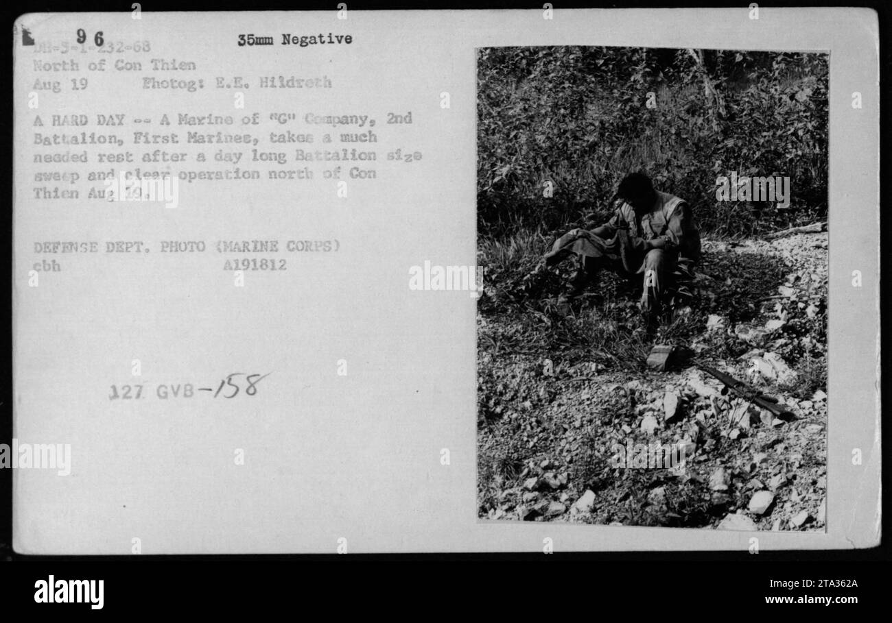 A Marine from G Company, 2nd Battalion, First Marines rests following a ...