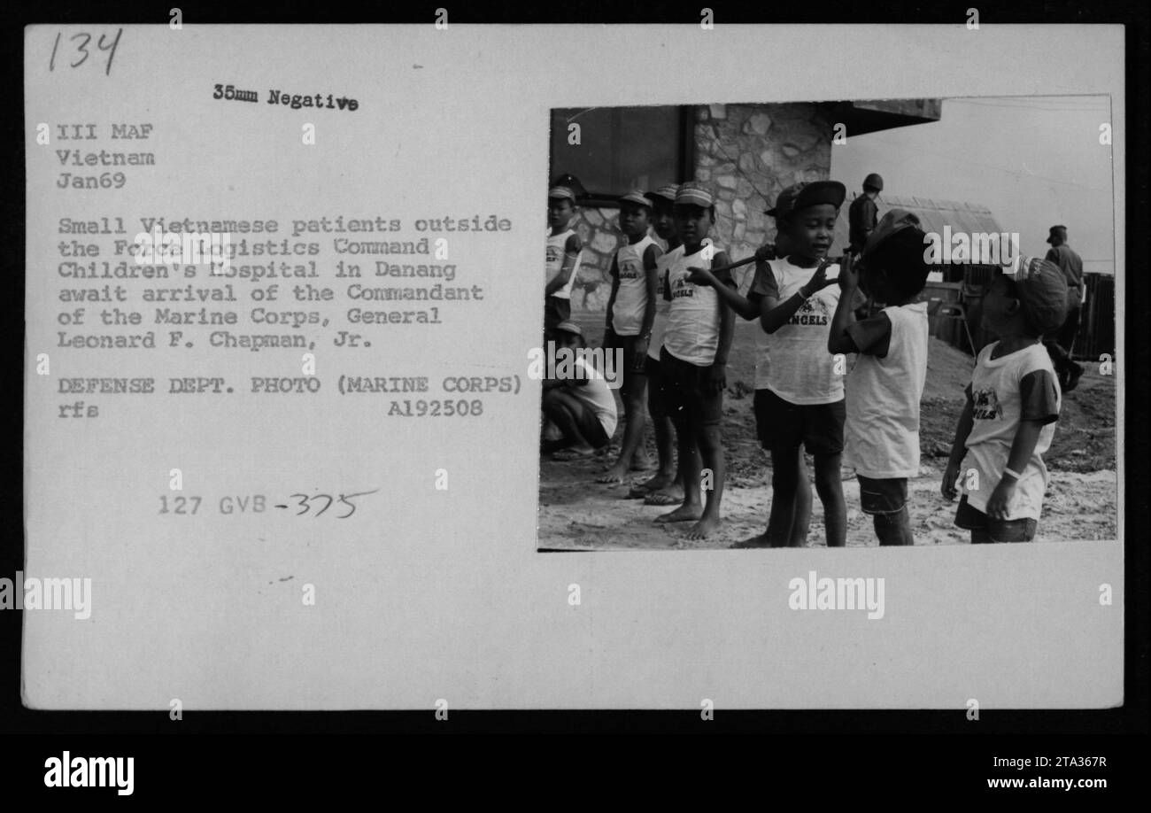 Vietnamese children await the arrival of General Leonard F. Chapman Jr ...