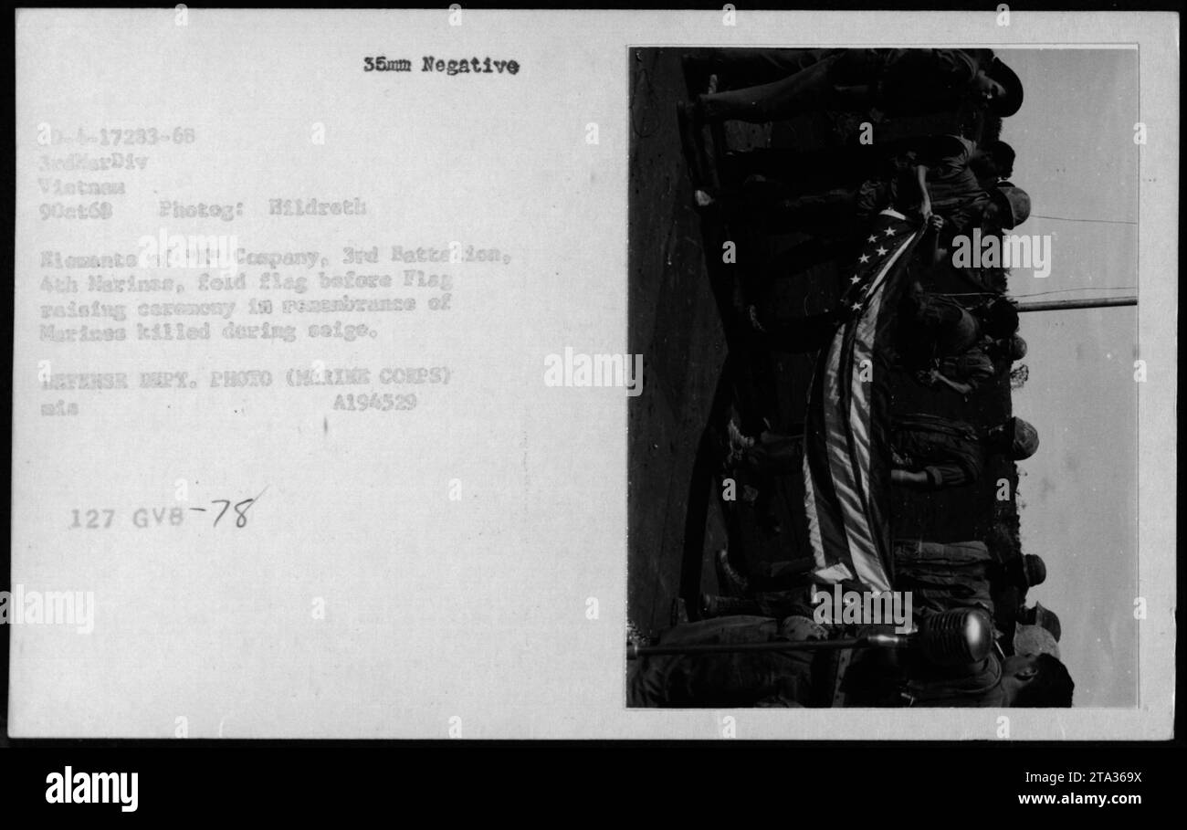 Marines from K Company, 3rd Battalion, 4th Marines fold the flag during ...