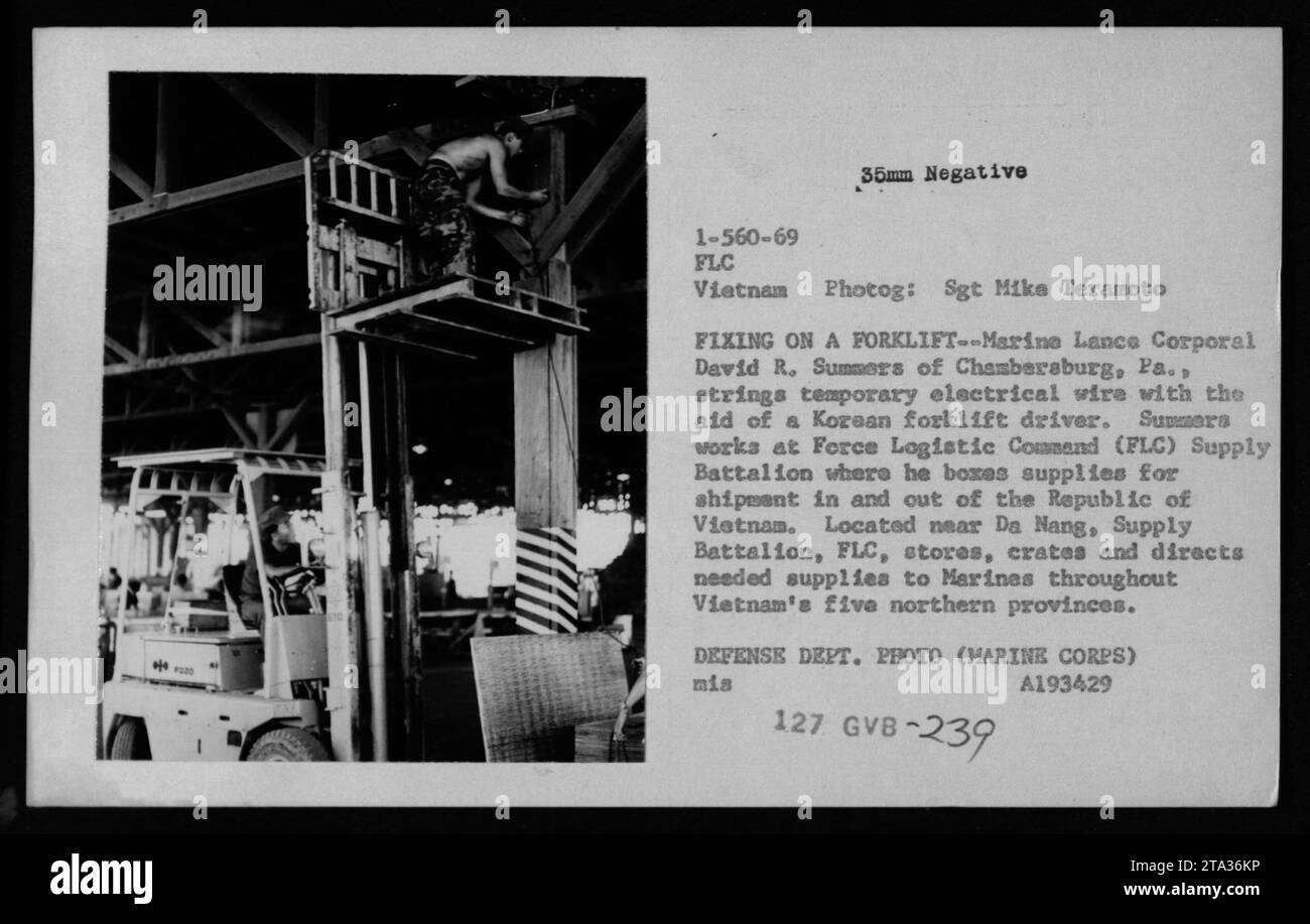 Lance Corporal David R. Summers and a Korean forklift driver string ...