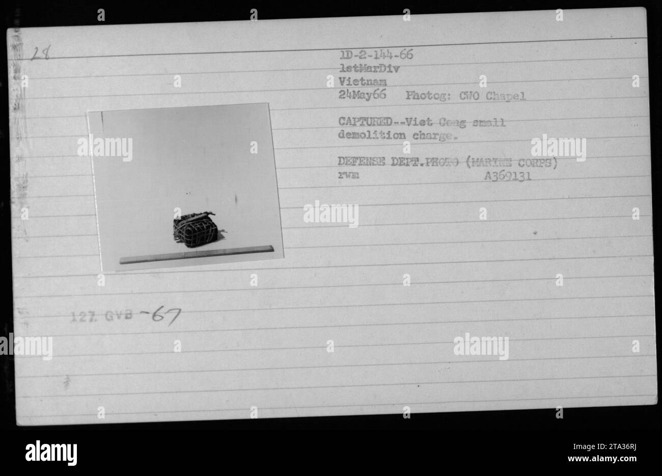 U.S. Army soldiers inspect a captured Viet Cong small demolition charge ...