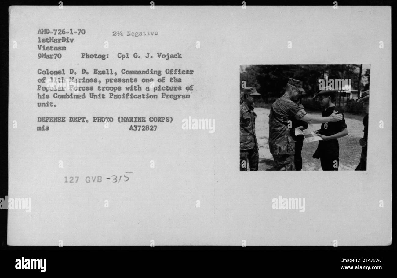 Colonel D. D. Ezell, Commanding Officer of 11th Marines, presents a ...
