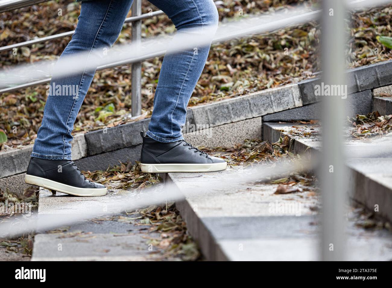 woman climbing the stone steps of the stairs. stone staircase with ...