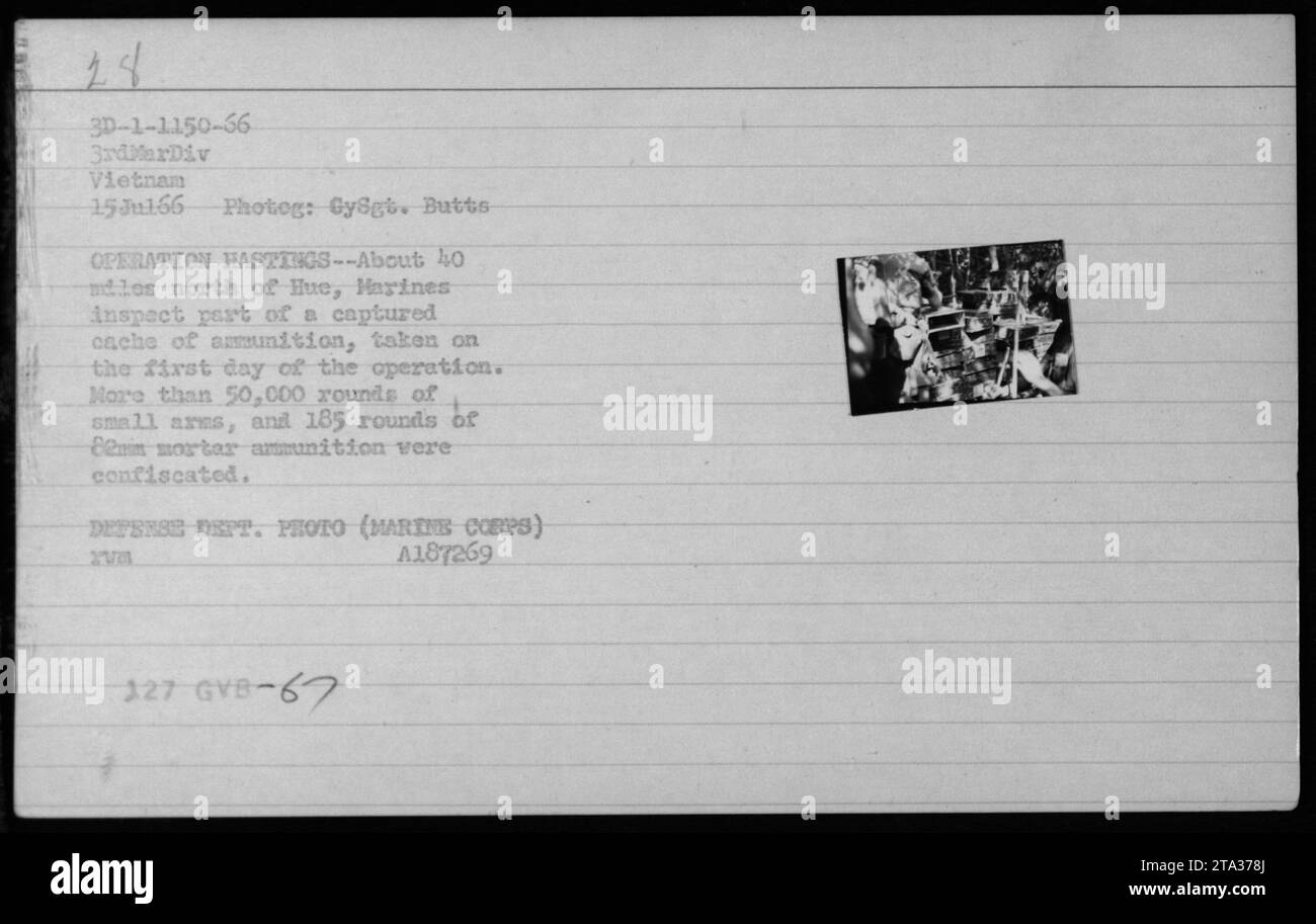 Marines inspect a captured cache of ammunition in Operation Hastings ...