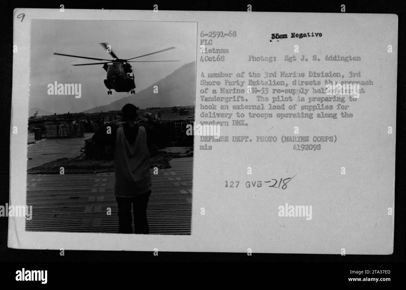 3rd Marine Division member directs a Marine CH-53 helicopter at ...