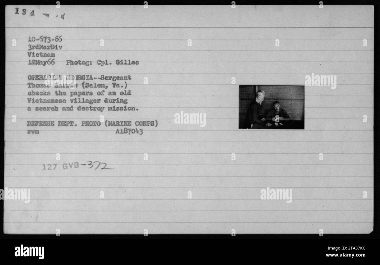 Sergeant Thomas Harris checks identification papers of an elderly ...