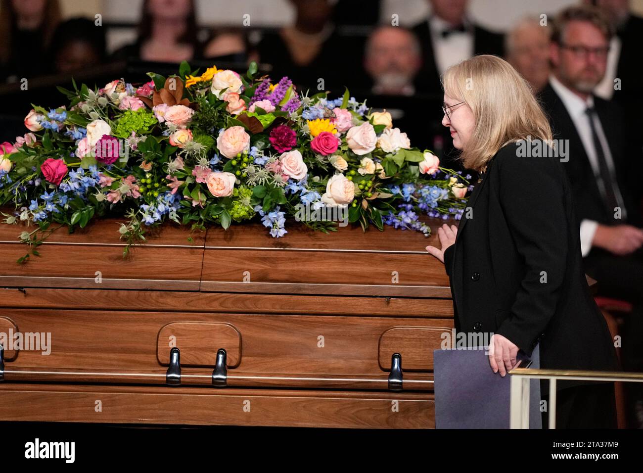 Amy Carter touches the casket after speaking at a tribute service for ...