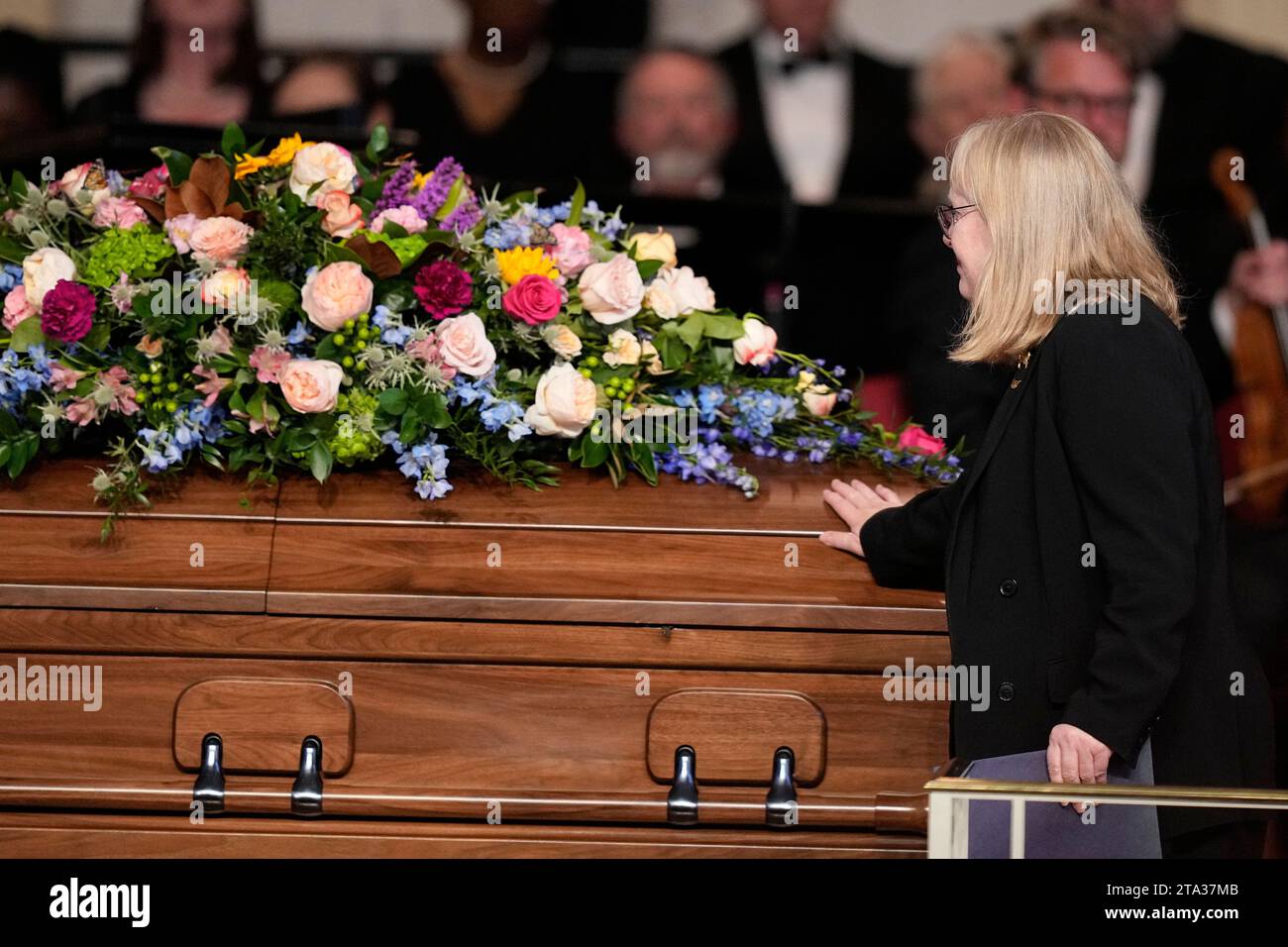 Amy Carter touches the casket after speaking at a tribute service for ...