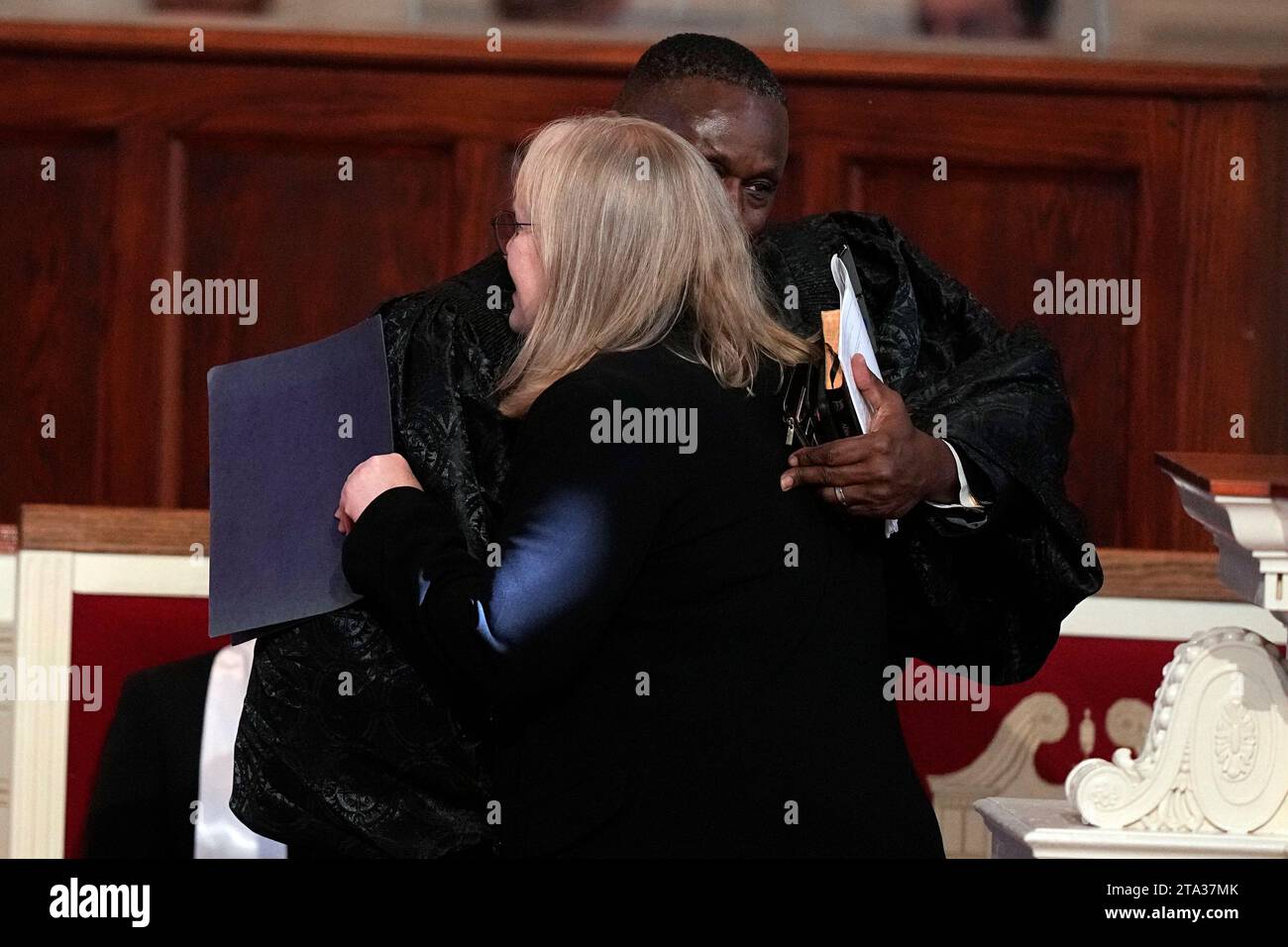 Amy Carter hugs Pastor Tony Lowden after speaking at a tribute service ...