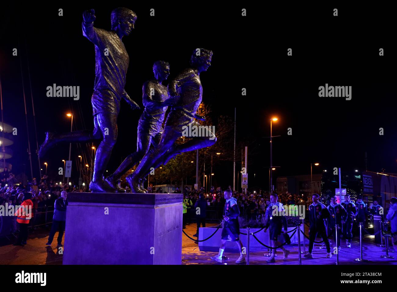 Manchester City players walk past the newly unveiled statue before the ...