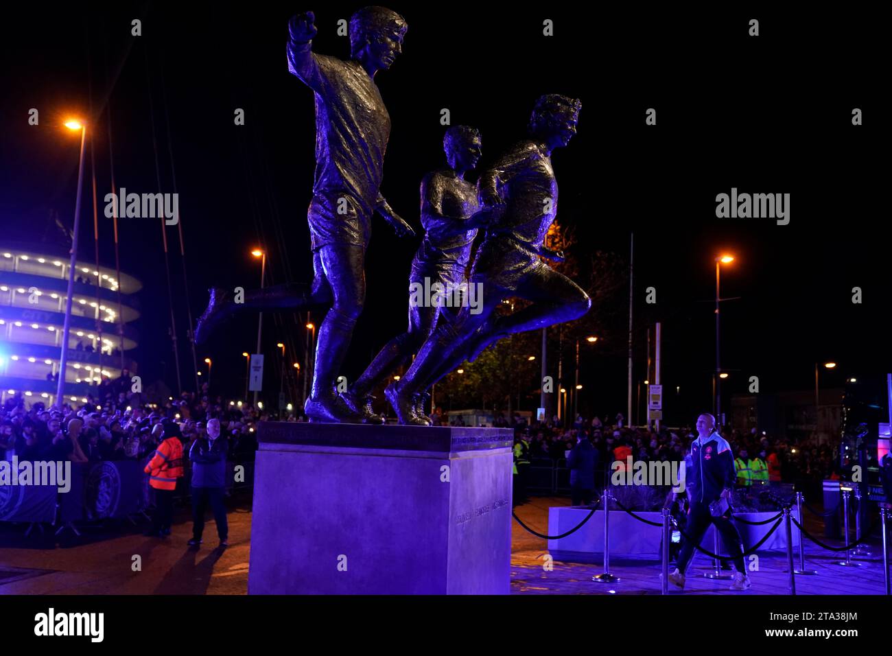 Manchester City's Erling Haaland walks past the newly unveiled statue ...