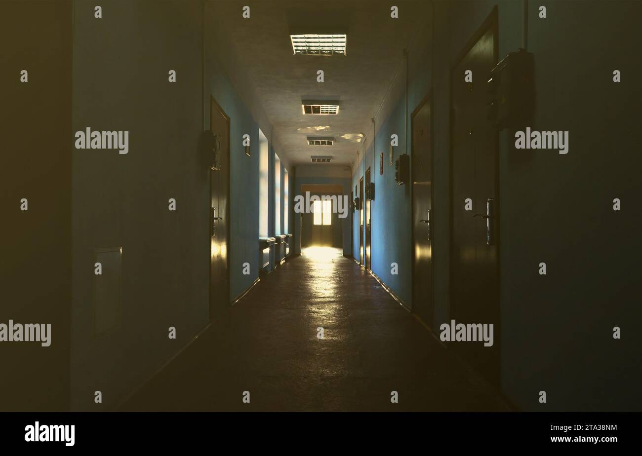 The gloomy corridor of a neglected public building. Public space in a ...