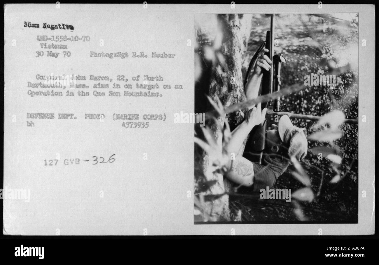 Corporal John Baron, 22, from North Dartmouth, Massachusetts, aims at a ...