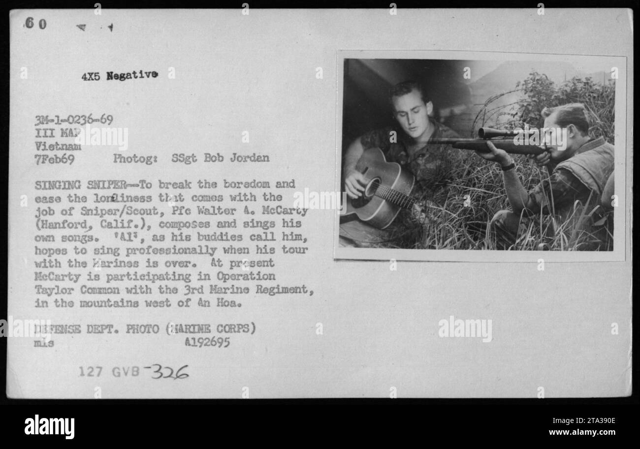 U.S. Marine Pfc. Walter 4. McCarty, a Sniper/Scout, singing self-composed songs during the ...